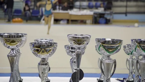 Awards cups, blurred athlete performance... | Stock Video | Pond5