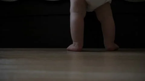 Baby barefoot in diapers learns to walk ... | Stock Video | Pond5