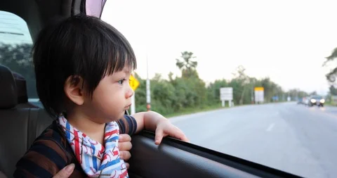 baby boy looking out of window car drivi... | Stock Video | Pond5