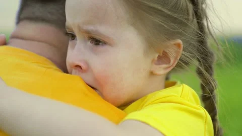 Baby daughter crying in park in arms of ... | Stock Video | Pond5