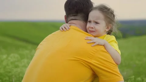 Baby daughter crying in park in arms of ... | Stock Video | Pond5