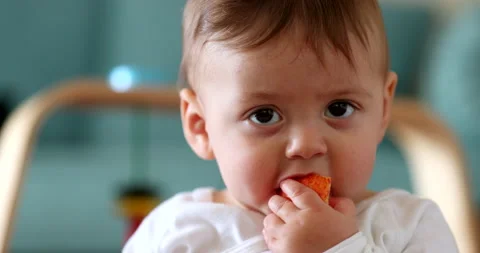 Baby face eating healthy snack fruit, in... | Stock Video | Pond5