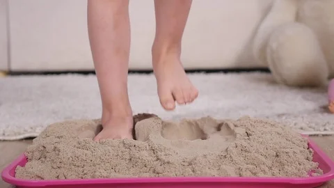 baby feet in the sand. with kinetic sand... | Stock Video | Pond5