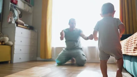 Baby first steps.Child kid runs across f... | Stock Video | Pond5