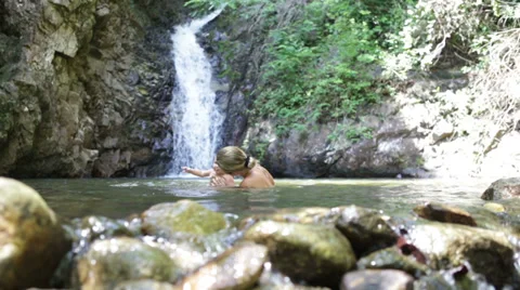 baby floating forward waterfall | Stock Video | Pond5