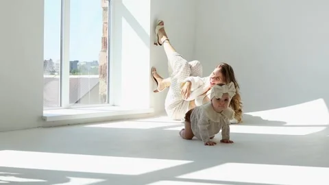 baby girl with a bow on her head is craw... | Stock Video | Pond5