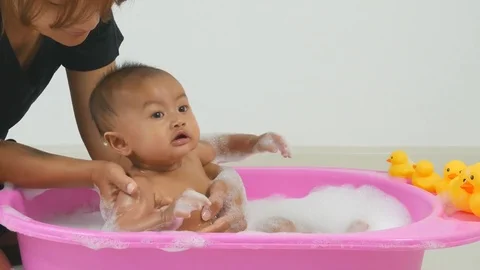 baby having a bath by his mother using w... | Stock Video | Pond5