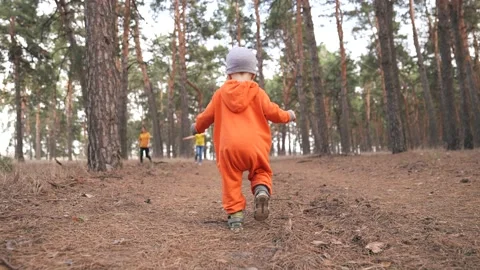 baby run. little boy in orange jumpsuit ... | Stock Video | Pond5