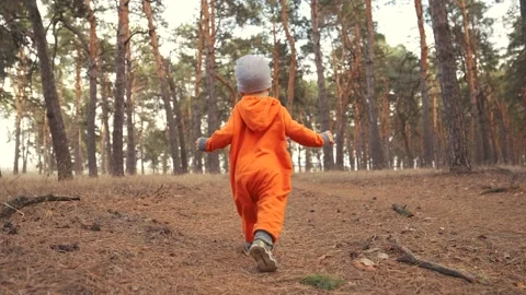 baby run. little boy in orange jumpsuit ... | Stock Video | Pond5
