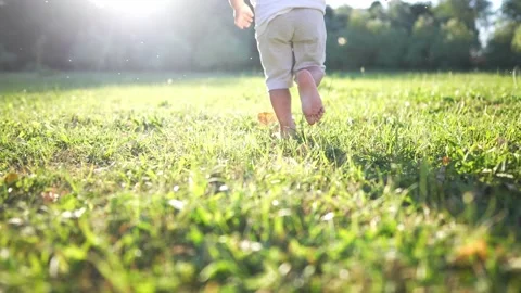 baby running in the park with bare feet.... | Stock Video | Pond5