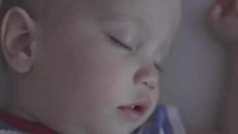 baby sleeping in crib face close-up with... | Stock Video | Pond5