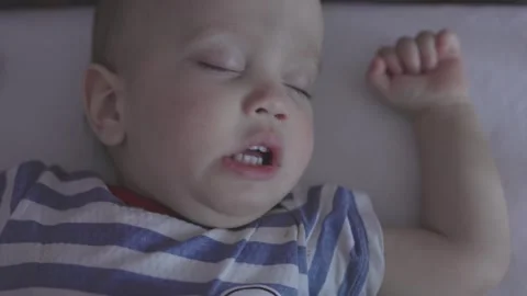 baby sleeping in crib face close-up with... | Stock Video | Pond5