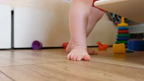 The baby stands on his toes to reach the... | Stock Video | Pond5