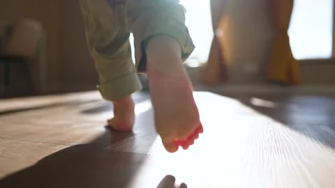 Baby takes first step on floor to his mo... | Stock Video | Pond5