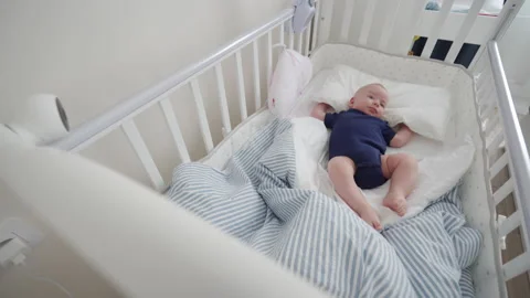 Baby wakes up in the crib, cute 3 months... | Stock Video | Pond5