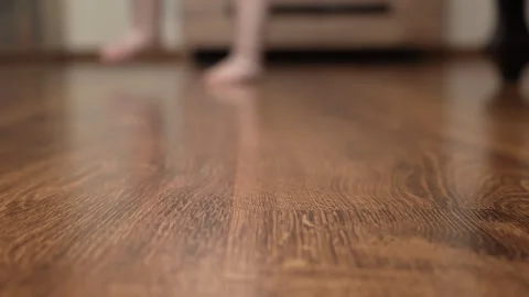 The baby's bare feet stomp on the parque... | Stock Video | Pond5