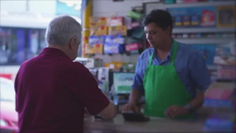 Back of customer at cashier of local sma... | Stock Video | Pond5