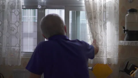 Back of elderly man looking out window v... | Stock Video | Pond5
