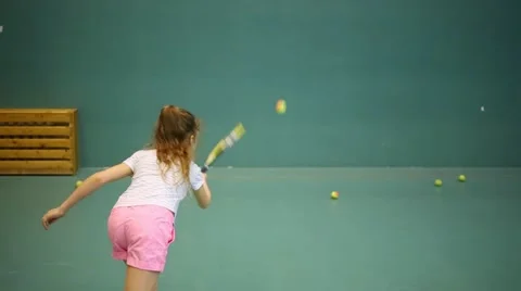 Back of girl learning to beat off balls ... | Stock Video | Pond5