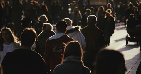 Back-lit crowd of people walking on stre... | Stock Video | Pond5