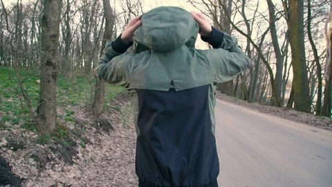 Back look of a young man in hood running... | Stock Video | Pond5