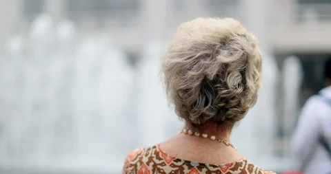 Back of older woman looking at fountain ... | Stock Video | Pond5