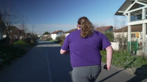 Back of one overweight man running outsi... | Stock Video | Pond5