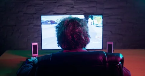 Back Shot of a Gamer Playing behind a co... | Stock Video | Pond5