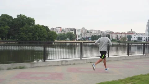 Back side view of young slim man running... | Stock Video | Pond5