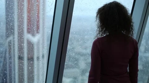 Back of slim woman looking into window o... | Stock Video | Pond5