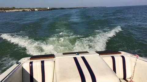 Back of speedboat sailing off into lake ... | Stock Video | Pond5