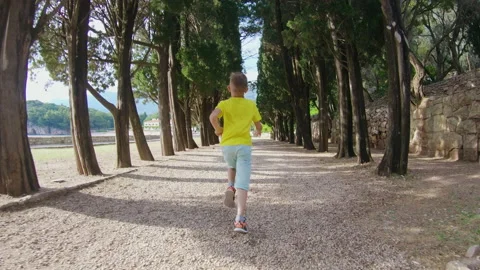 Back view of 7-8 year old running boy in... | Stock Video | Pond5