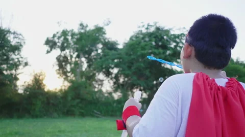 Back view of Asian boy wearing hero cost... | Stock Video | Pond5