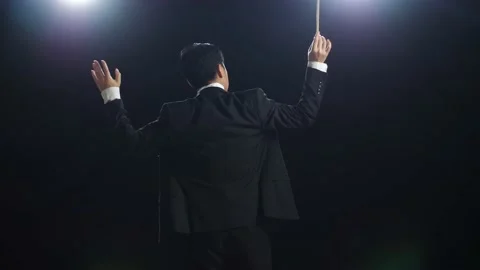 Back View Of Asian Conductor Man Holding... | Stock Video | Pond5