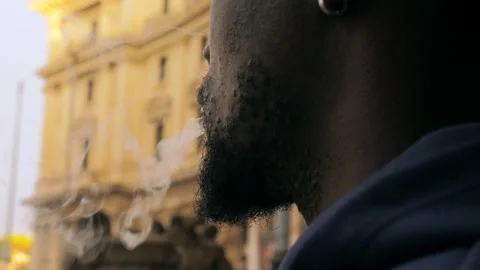 Back view of a black man smoking: smoke,... | Stock Video | Pond5