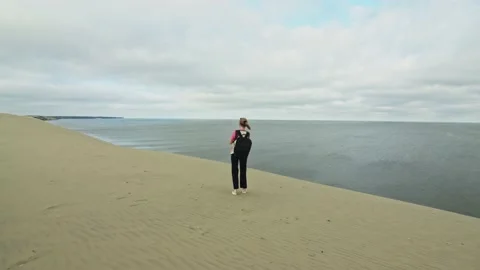 Back view of blonde girl walking on top ... | Stock Video | Pond5