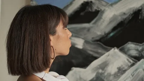 Back view of calm young woman with headp... | Stock Video | Pond5