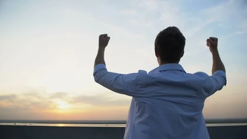 Back view of Caucasian man raising hands... | Stock Video | Pond5