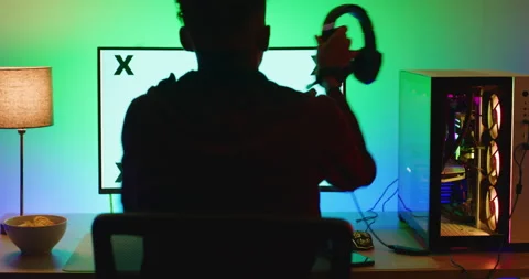 Back view of a computer gamer wearing he... | Stock Video | Pond5