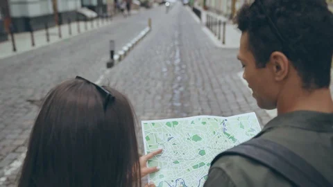 back view of couple with map walking on ... | Stock Video | Pond5