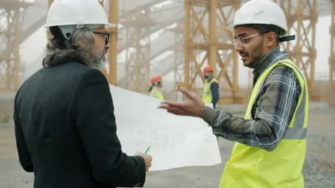 Back view of engineers discussing constr... | Stock Video | Pond5
