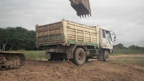 back view of an excavator loading earth ... | Stock Video | Pond5