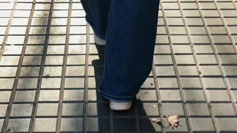 Back view of female footsteps crossing b... | Stock Video | Pond5