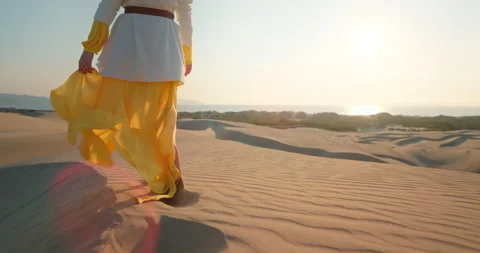 Back view of female walking by deep dune... | Stock Video | Pond5