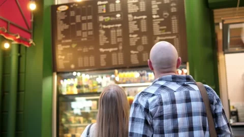 Back view of a girl and a guy, customers... | Stock Video | Pond5