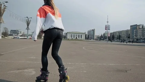 Back view of girl on roller skates. Attr... | Stock Video | Pond5