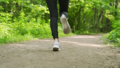 Back view of a girl's feet running throu... | Stock Video | Pond5