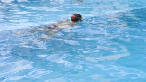 Back view of a kid swimming in the pool ... | Stock Video | Pond5