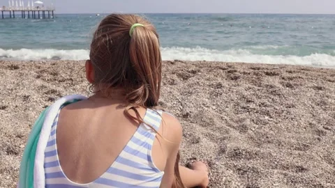 Back view of little girl in stripy swims... | Stock Video | Pond5