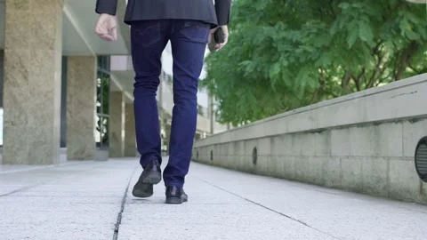 Back view of male legs walking through p... | Stock Video | Pond5
